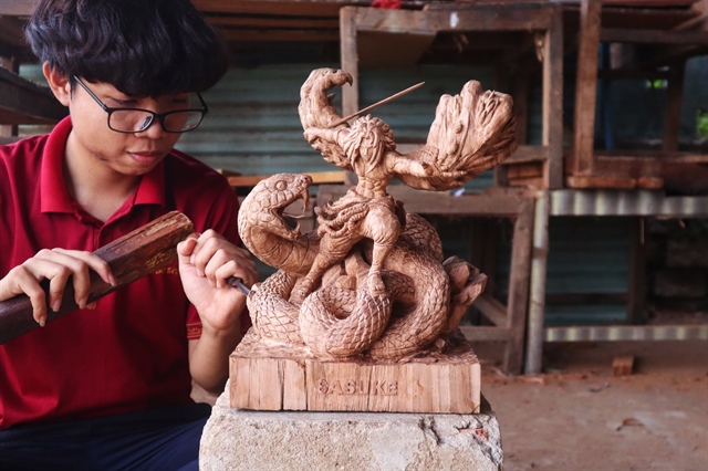 Young woodcarver puts modern twist on traditional craft - Asia News ...