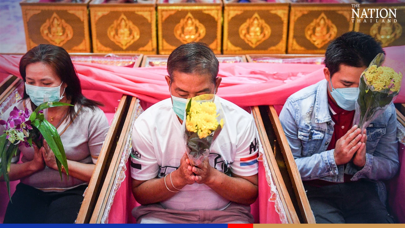 Devotees climb into coffins for Thailand’s strangest New Year ceremony ...